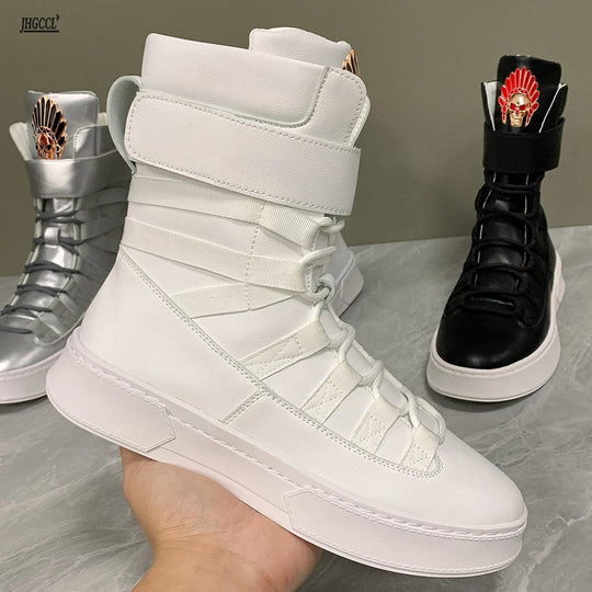 Loading image: Black high-top sneaker with white sole on a gray surface